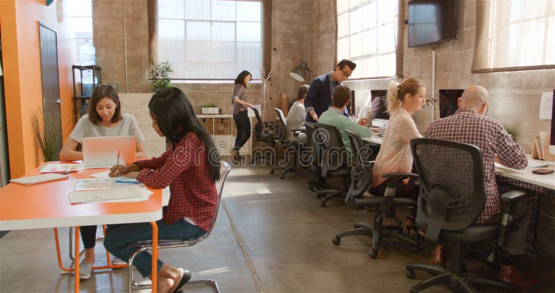 Designers in Creative Business Working at Desks in Modern Open Plan ...