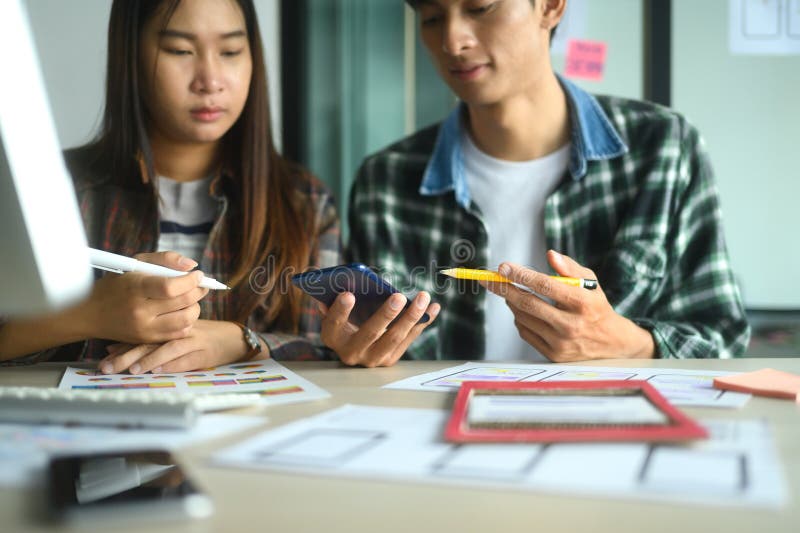 Designers Discussing User Interface Ideas while Reviewing a Smartphone ...