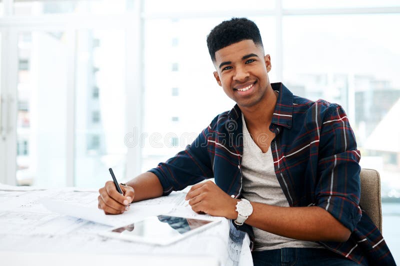 The Designs are Looking really Good. Portrait of a Young Man Going Over ...