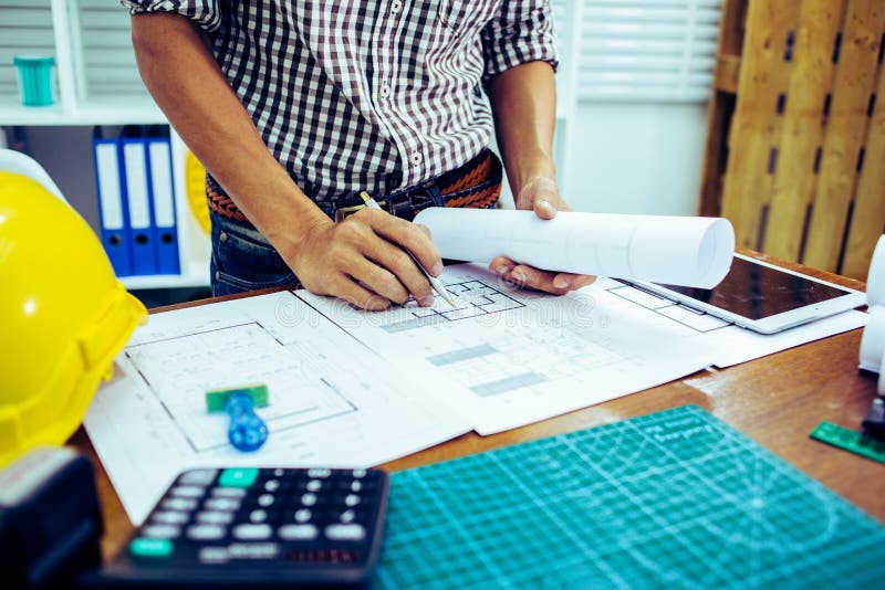 Desk of Architectural Working Project in Construction Site,with Drawing ...