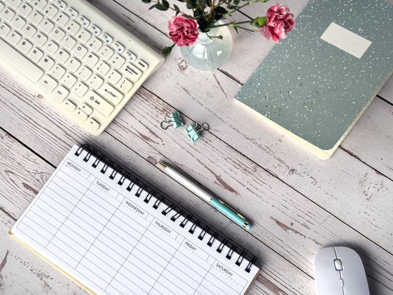 Desk with Blank Weekly Planner, Notepad, Keyboard, Mouse, and Flowers ...