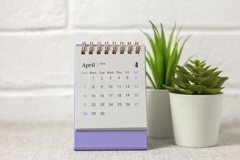 Desk Calendar for April 2024 and a Clock on the Table Stock Photo ...