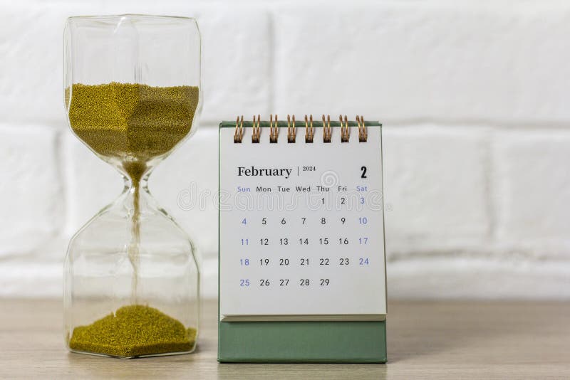 Desk Calendar for February 2024 and a Clock on the Table with Copy ...