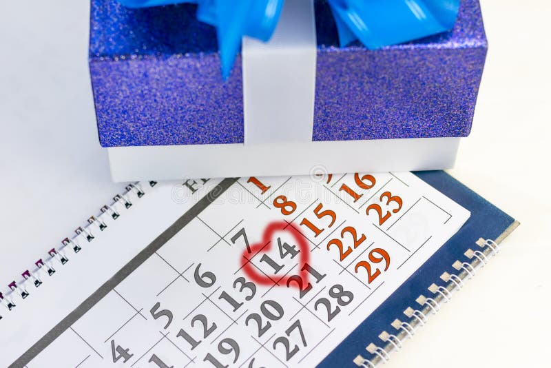 The Desk Calendar Has a Red Number 14. it Has a Gift Box Next To it ...