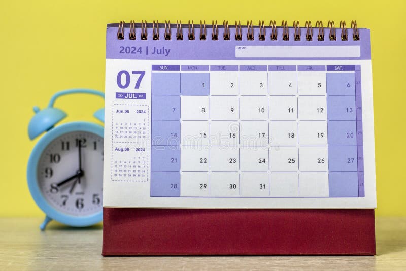 Desk Calendar for July 2024 on the Table Next To the Alarm Clock Stock ...