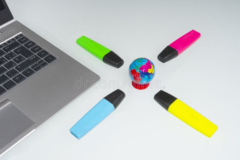 Desk with a Computer and a Ball of the World Surrounded by Colored ...