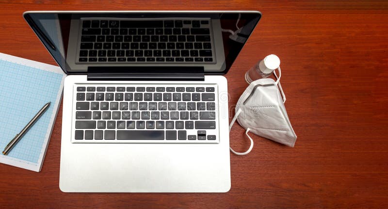 Desk with Computer, Disinfectant Gel and MaskTop View of Desktop with ...