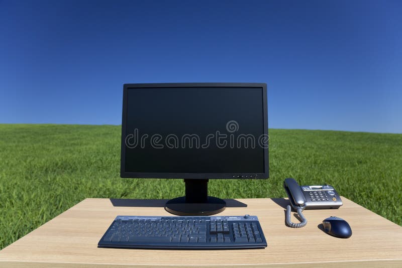 Desk and Computer in Green Field with Blue Sky Stock Photo - Image of ...