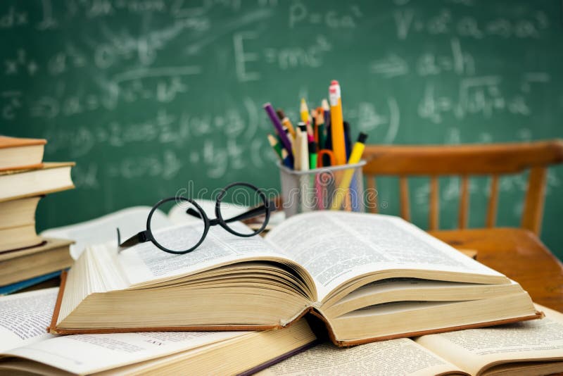 Desk Full of Open Books Over Blackboard Stock Image - Image of ...