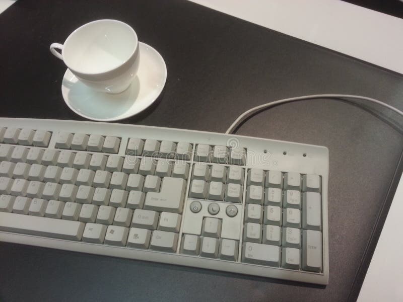 Desk with keyboard and cup stock photo. Image of workstation - 42886526
