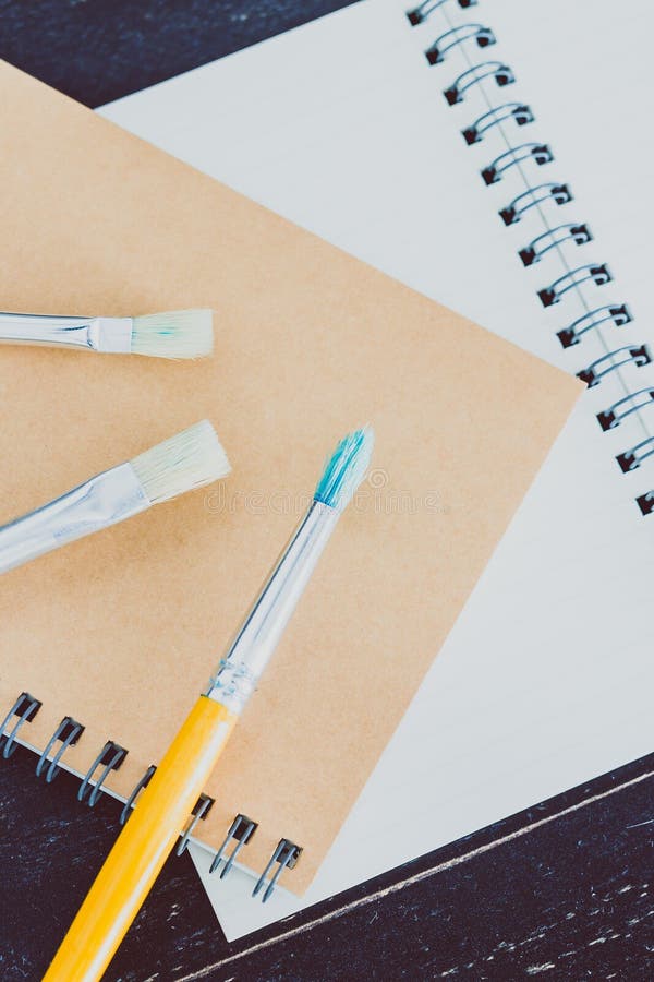 Desk with Notepads and Watercolour Brushes with Scrunched Paper Balls ...