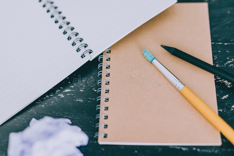 Desk with Notepads and Watercolour Brushes with Empty Pages and ...