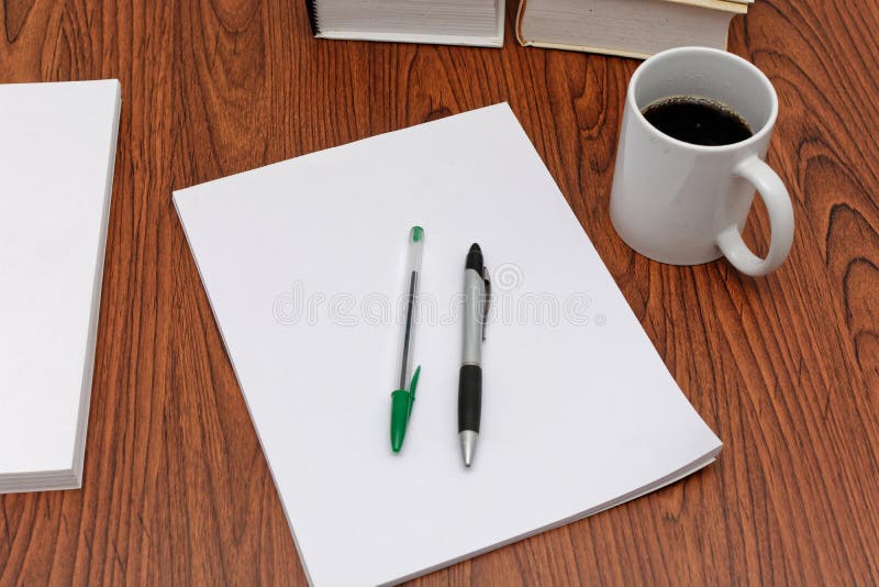 Desk with Papers, Books, Pens and a Cup of Coffee on Top Stock Photo ...