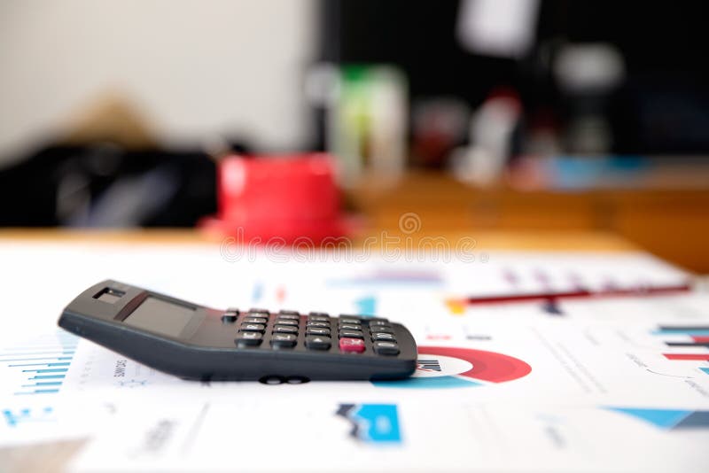 A Desk of Papers and a Calculator Stock Photo - Image of document ...