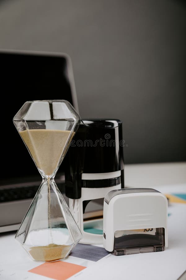 Desk Table with Laptop, Hourglass and Rubber Stamp. Concept of Office ...