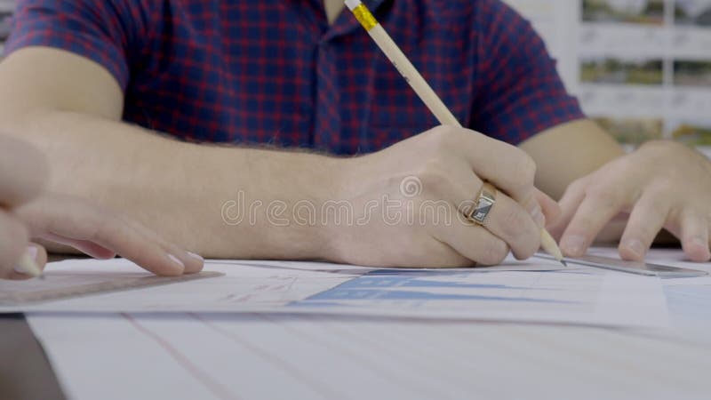 At Desk Two Engineers Draw a Ruler and a Pencil on Sheet. Stock Video ...