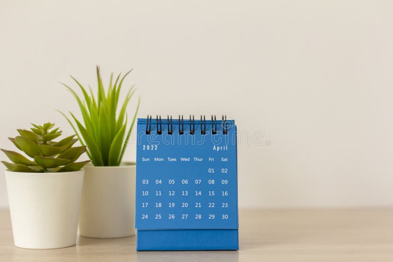 Desktop Blue Calendar for April 2022 on the Table Stock Photo - Image ...