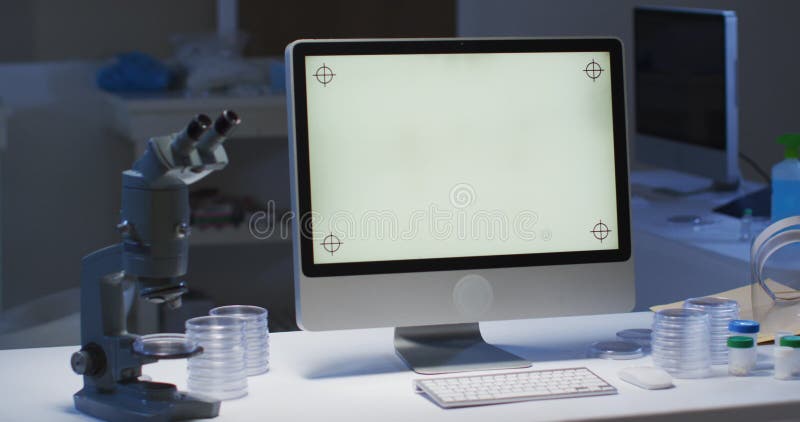 Desktop Computer with Illuminated Screen at a Workstation in an Empty ...