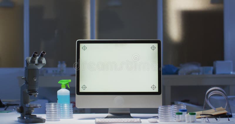 Desktop Computer with Illuminated Screen at a Workstation in an Empty ...