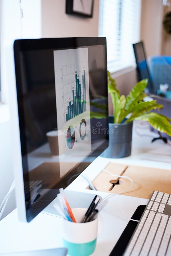 A Desktop Computer Screen with a Bar Graph and Pie Chart in Blue Stock ...