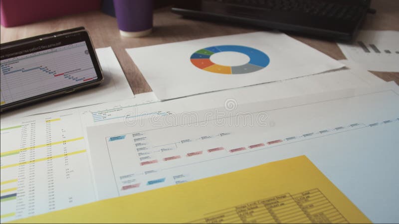 Desktop with Documents and Graphs and More Tables Stock Video - Video ...