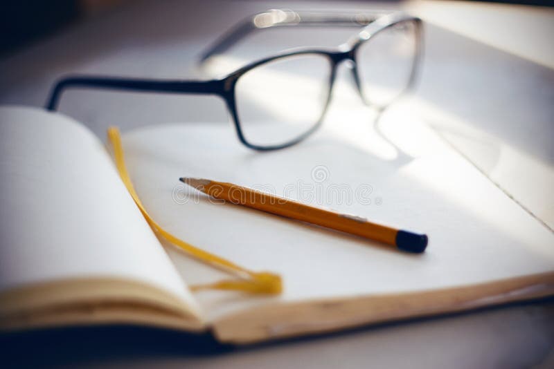 On the Desktop are Glasses, a Notebook and a Pencil Stock Image - Image ...