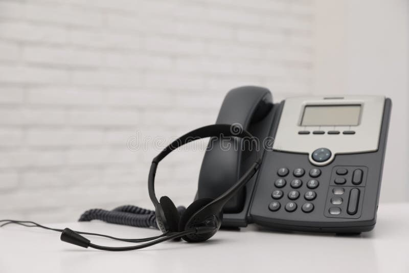Desktop Telephone and Headset on White Table in Office, Space for Text ...
