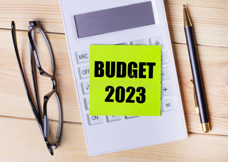 On the Desktop There is a Green Sticker with the Text BUDGET 2023, a ...