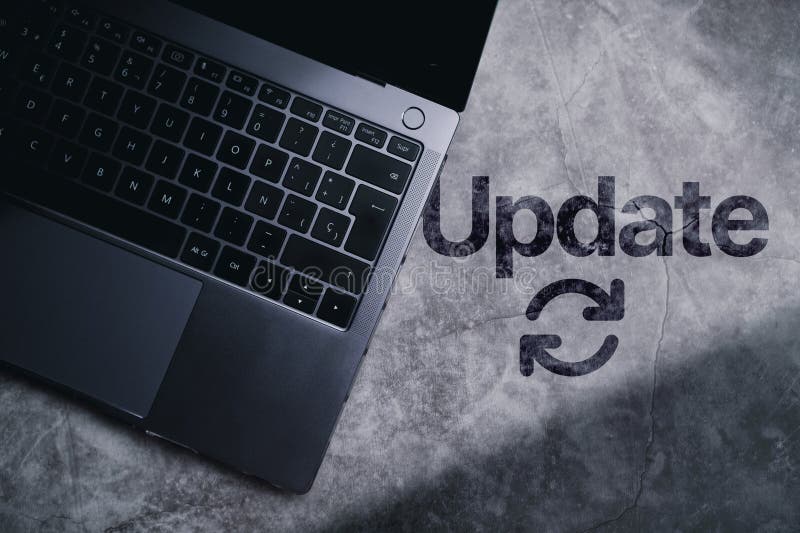 Desktop Top View with Laptop and the Word Update Written on Surface ...