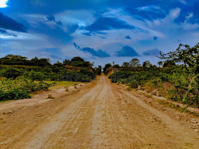 A Desolate road stock image. Image of cloud, blue, road - 152204209