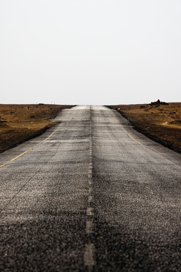 Desolate Road Extends through a Barren, Rocky Landscape Stock Photo ...