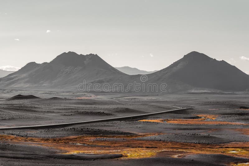 Desolate Road through Volcanic Terrain with Mountain Backdrop. Stock ...