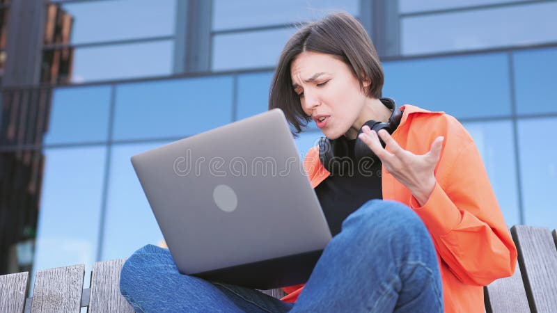 Woman Struggling with Broken Computer and Closing it Outdoor Stock ...