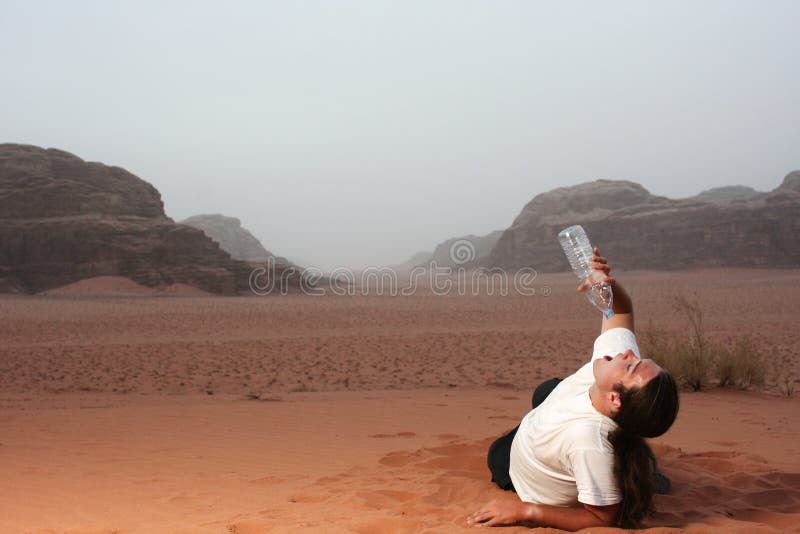 Desperate Man in the Desert Drinking Last Drops of Water from an Empty ... Desperate Man in the Desert Drinking Last Drops of Water from an Empty ...
