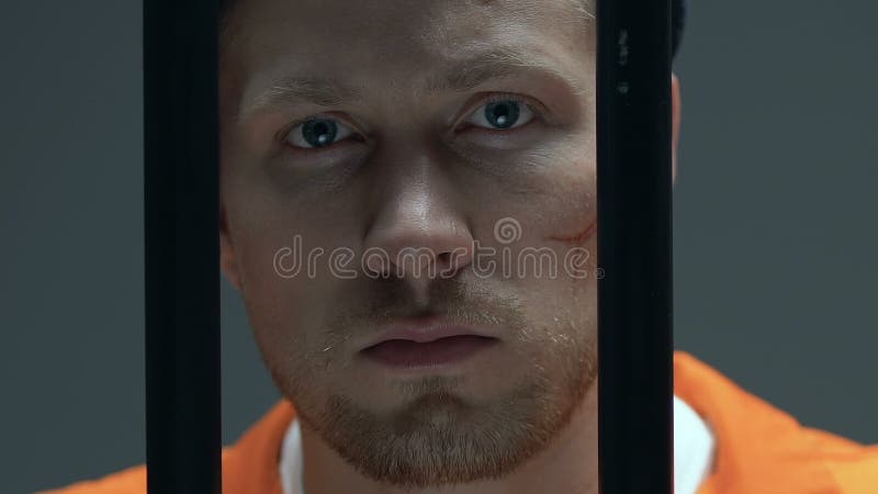 Criminal Looking Out from Prison Cell through the Jail Bars Closeup ...