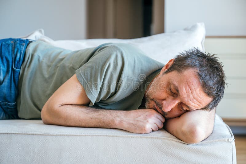 Desperate Sad Man Laying on Sofa Couch, Feeling Miserable and Depressed ...