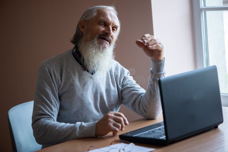 Desperate Senior Man Using Laptop and Looking for Information in ...