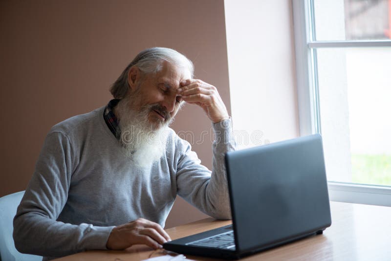 Desperate Senior Man Using Laptop and Looking for Information in ...