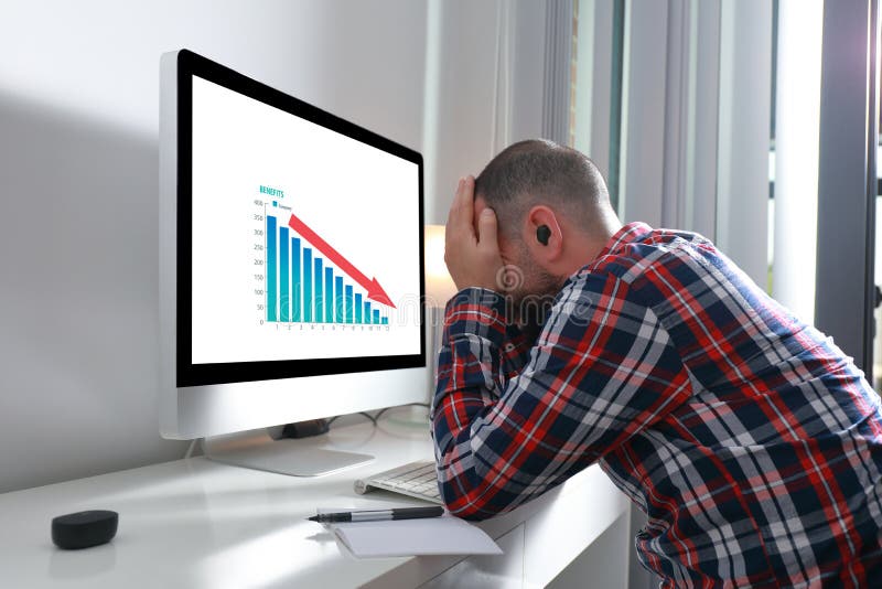 Desperate Young Man in Front of Computer with Bad Financial News on the ...