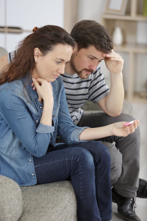 Despondent Couple Looking at Pregnancy Test Stock Image - Image of ...