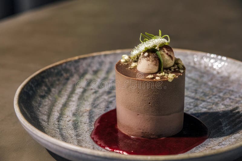 Gourmet Chocolate Mousse Dessert with Matcha Crumble and Berry Sauce on ...