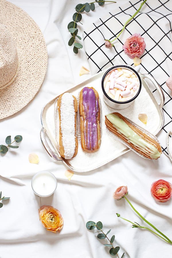 Dessert Flat Lay with Eclairs on the Tray on Bed Sheets. Stock Photo ...