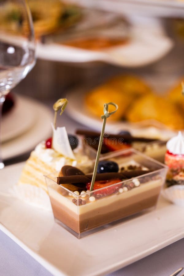 Dessert Layers in Plastic Dishes Close-up on the Buffet Table. Stock ...