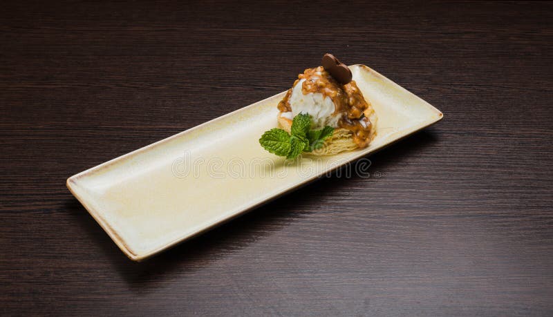 Dessert with Puff Pastry and Ice Cream Drizzled with Caramel on a Plate ...