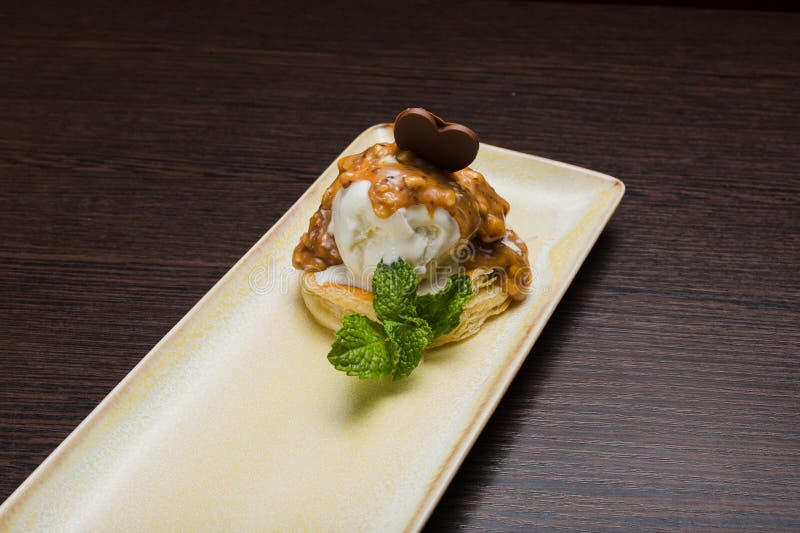 Dessert with Puff Pastry and Ice Cream Drizzled with Caramel on a Plate ...