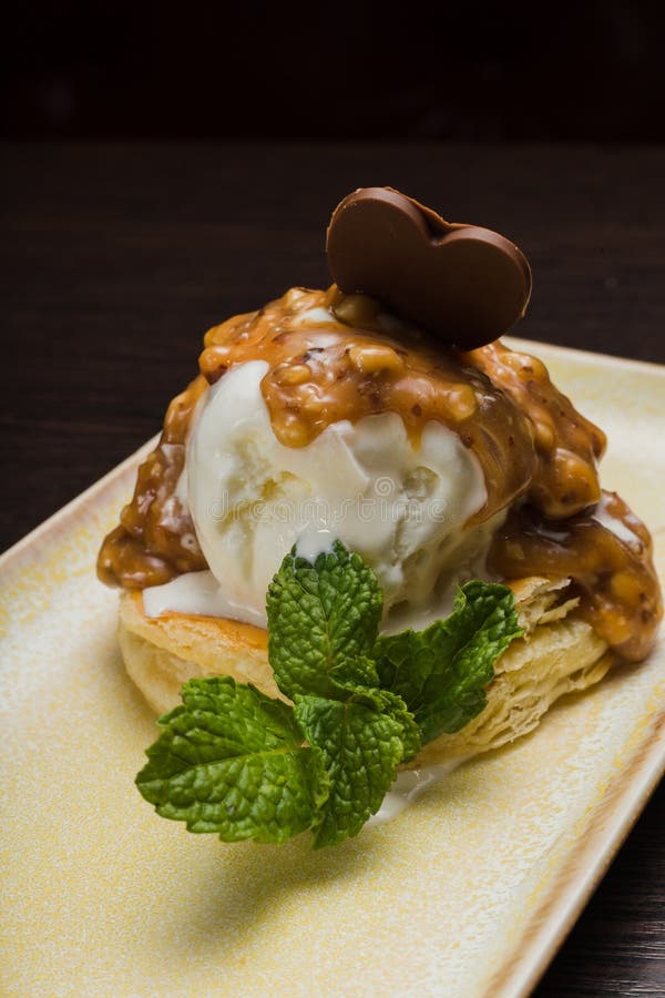 Dessert with Puff Pastry and Ice Cream Drizzled with Caramel on a Plate ...