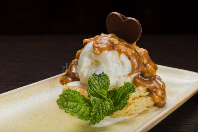 Dessert with Puff Pastry and Ice Cream Drizzled with Caramel on a Plate ...