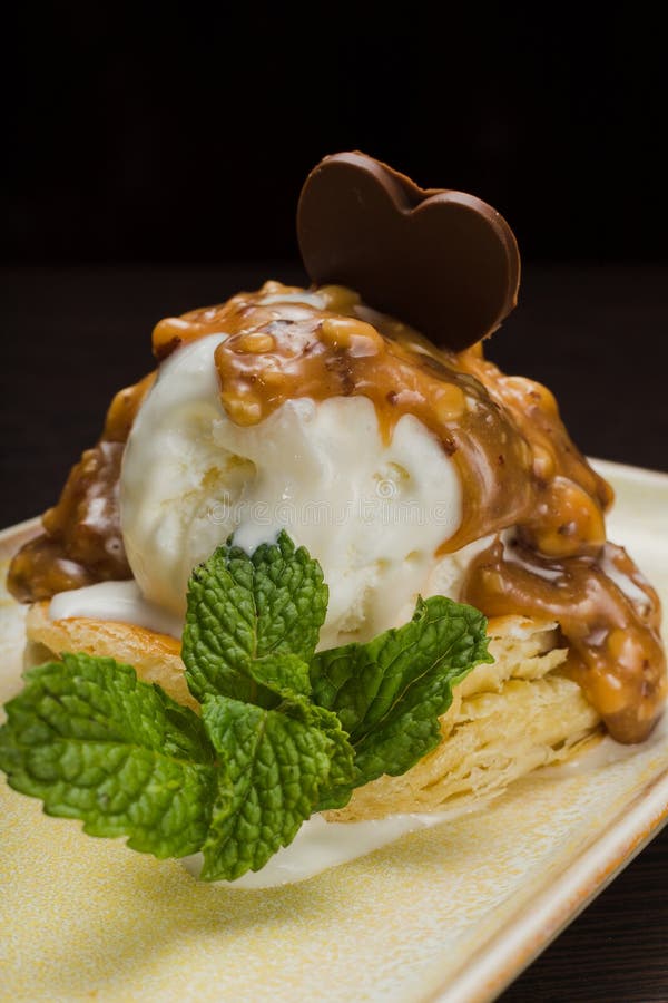 Dessert with Puff Pastry and Ice Cream Drizzled with Caramel on a Plate ...