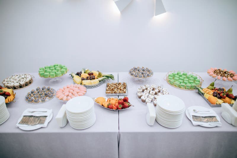 Dessert Table with Appetizers and Cakes at a Wedding Party in a ...