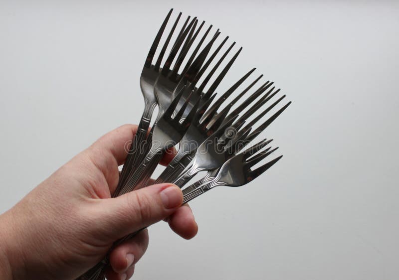 Dessert and Table Forks in a Human Hand on Clean Backdrop Stock Image ...